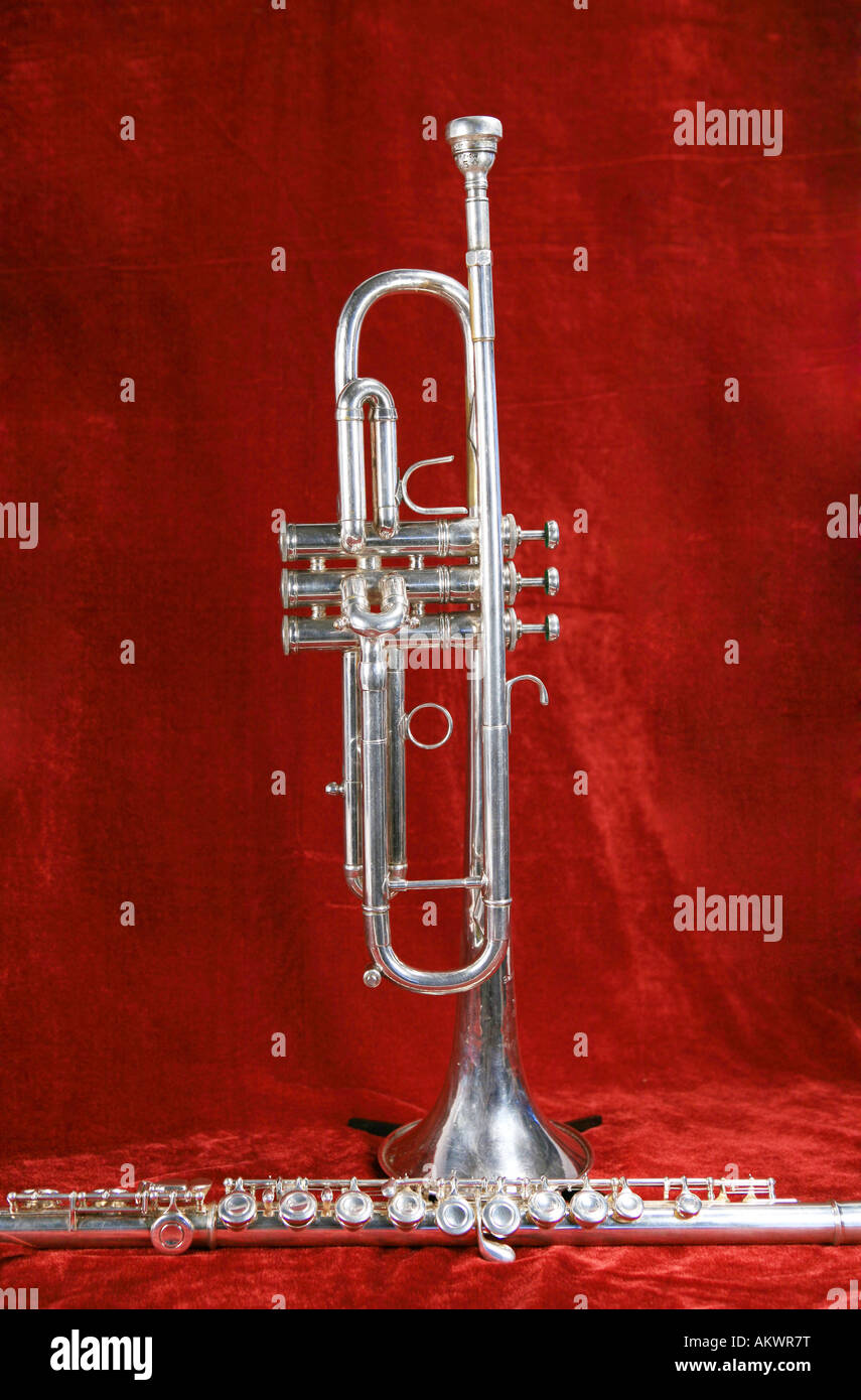 Silver trumpet and flute on red velvet background Stock Photo - Alamy