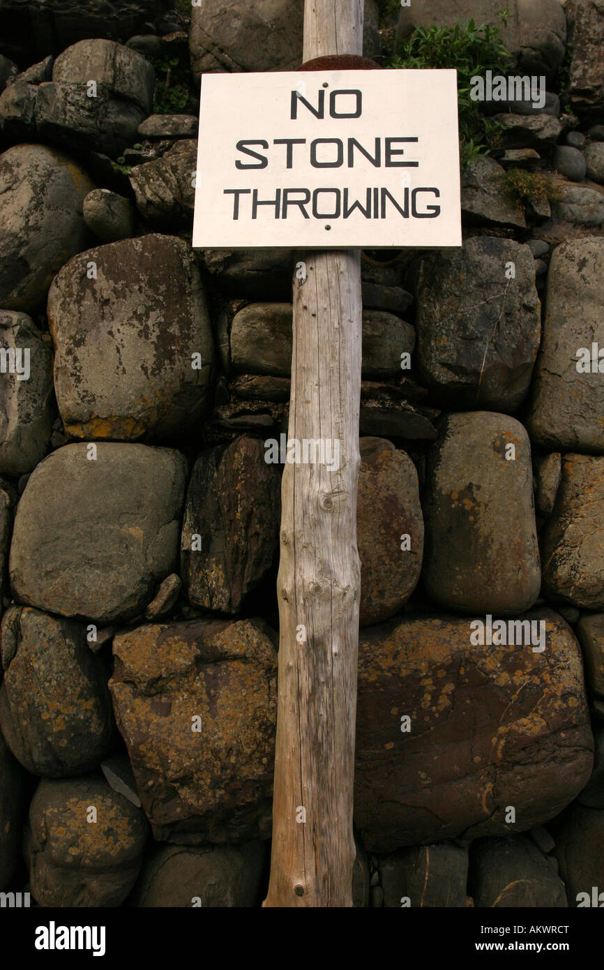 No stone throwing sign against granite stone harbour wall Clovelly ...