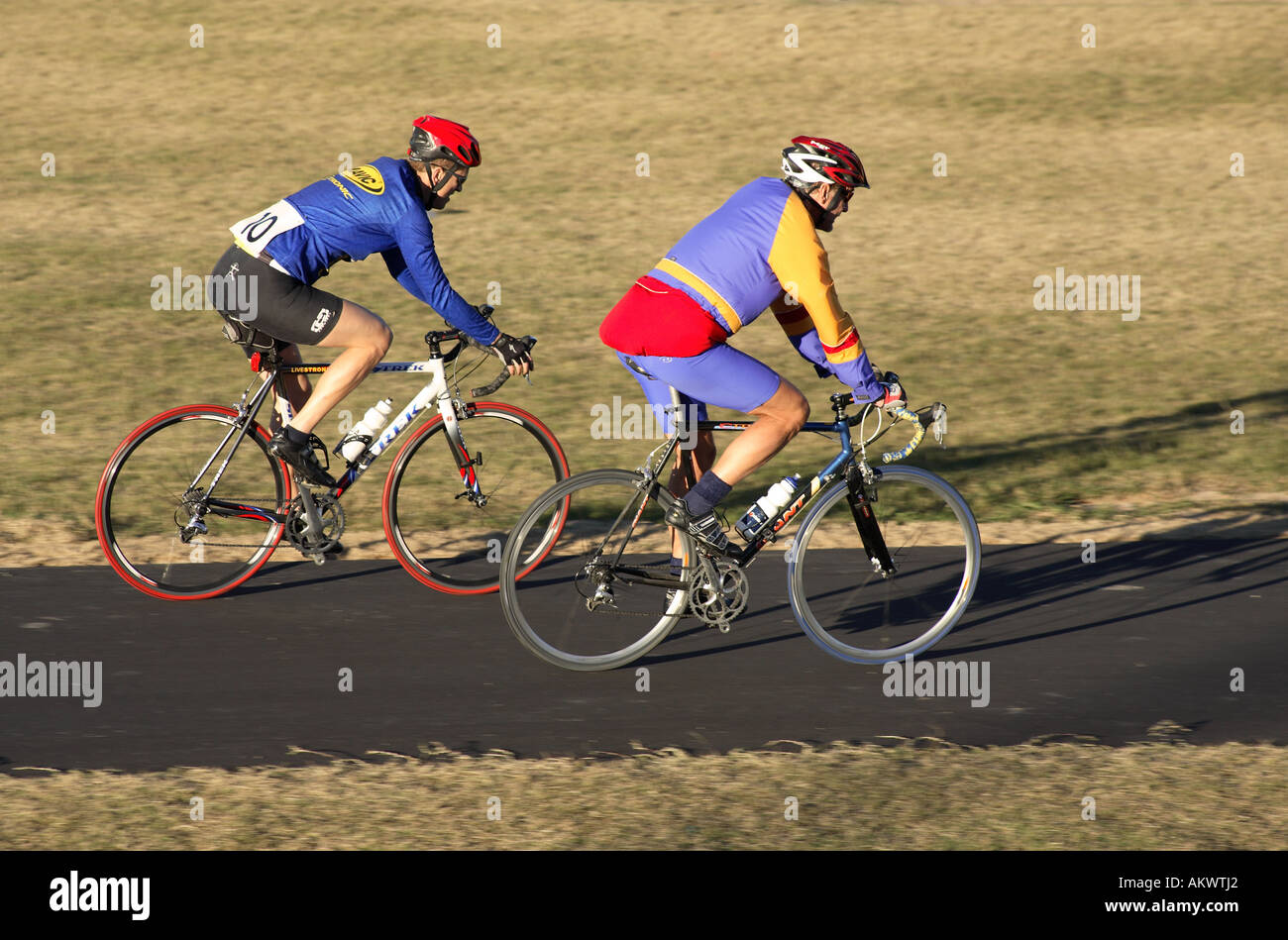 two bicycle riders racing on the track Stock Photo - Alamy