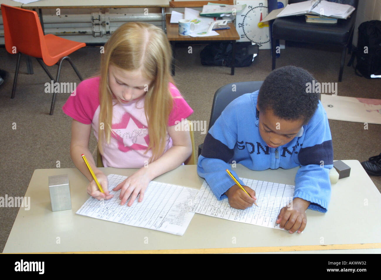 Primary students working at their lessons in classroom Stock Photo - Alamy