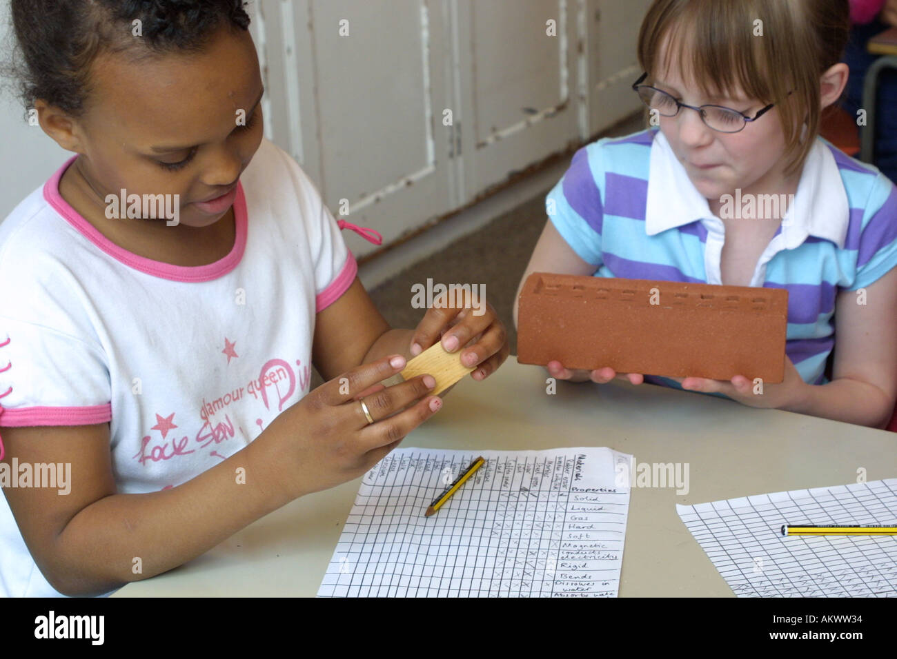 primary students studying brick and wood material in classroom Stock ...