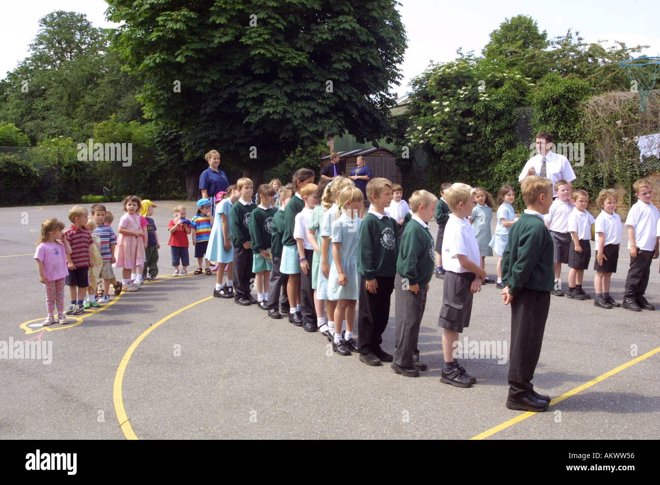 children queuing up in village school playground Stock Photo - Alamy