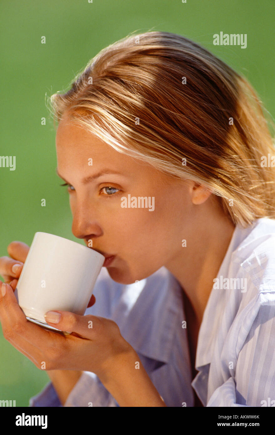 Girl sipping tea Stock Photo - Alamy