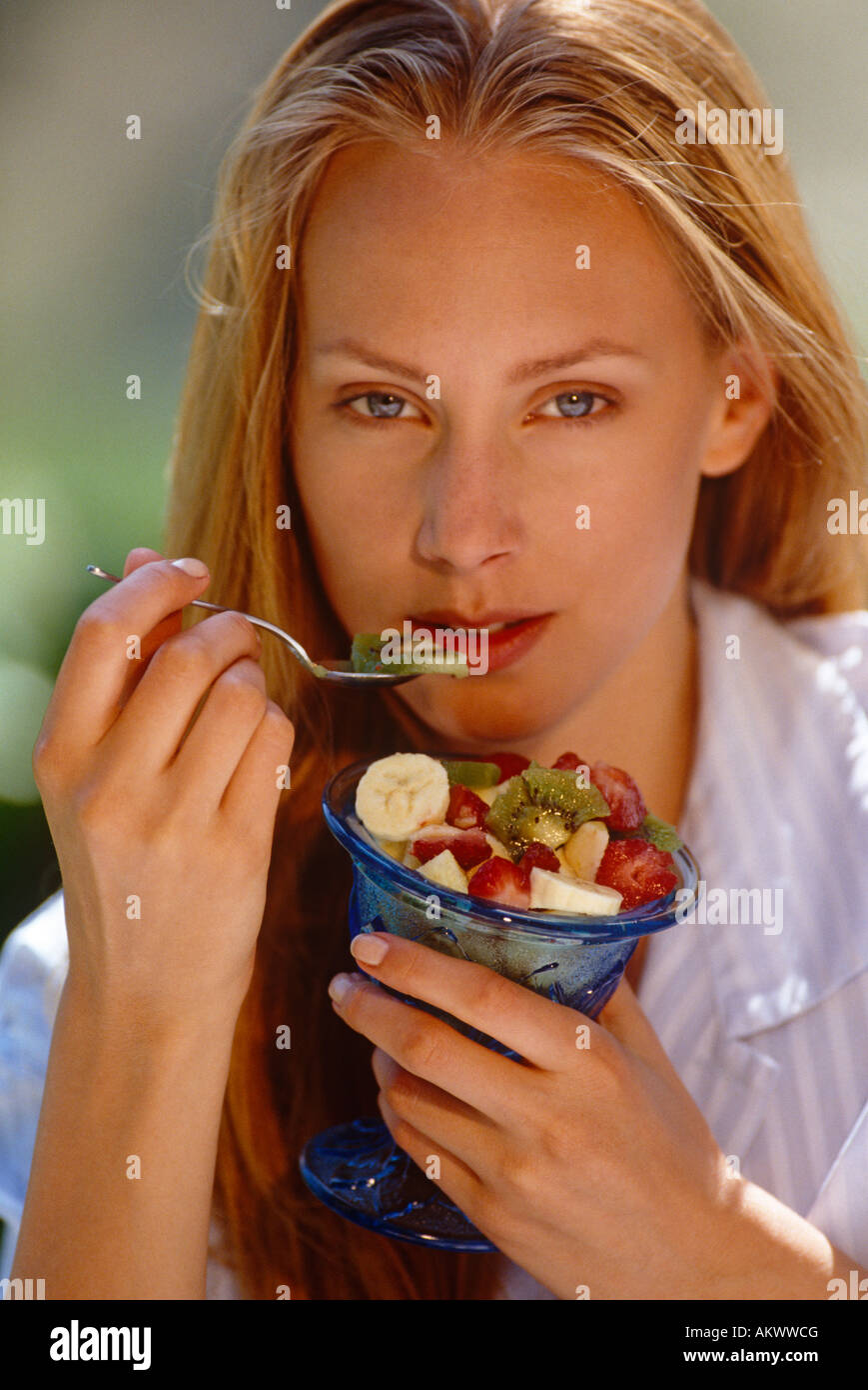 Girl eating fruit salad Stock Photo - Alamy