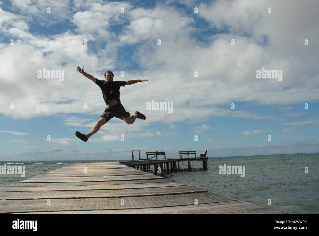 man jumping on dock Stock Photo - Alamy