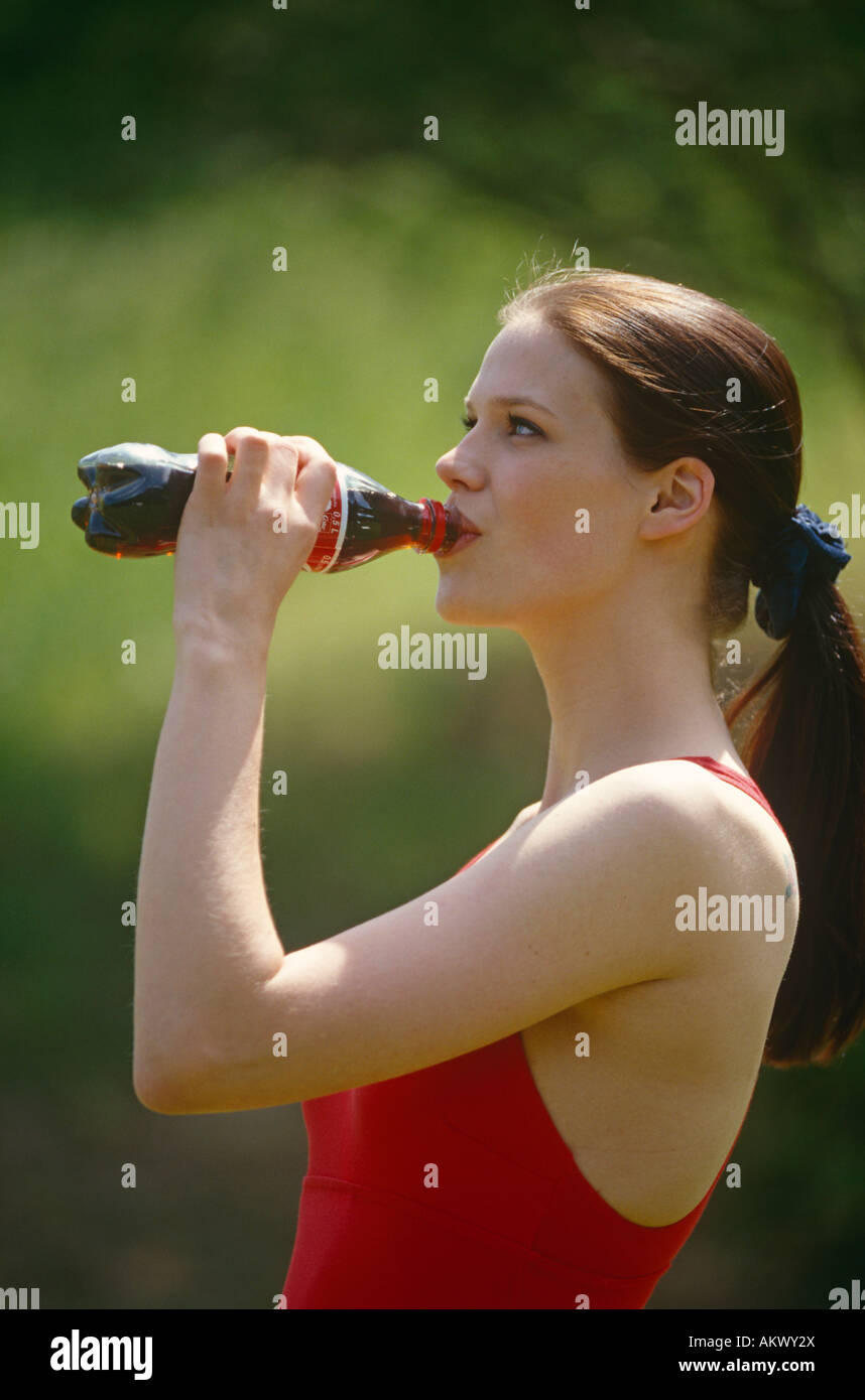 Girl drinking fizzy drink outdoors Stock Photo - Alamy