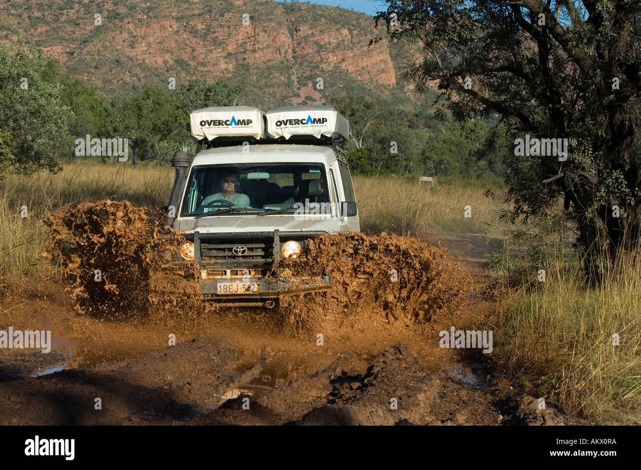 Offroad vehicle driving through mud, Gibb Road, Northern Territory ...