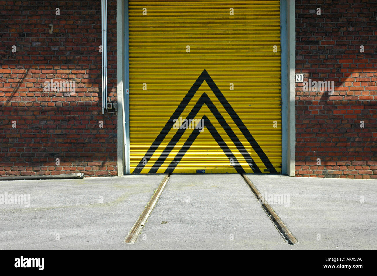 Yellow gate with railroad tracks Stock Photo - Alamy