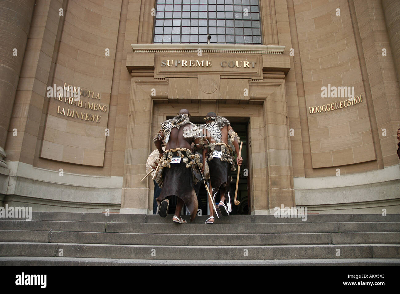 Men dressed in traditional clothing enter the High Court during the ...