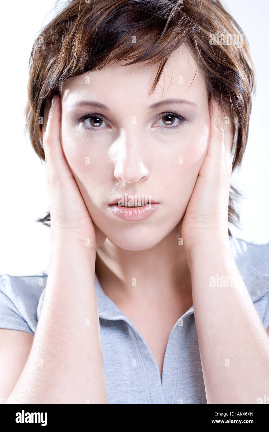 Woman shutting ears, portrait Stock Photo - Alamy