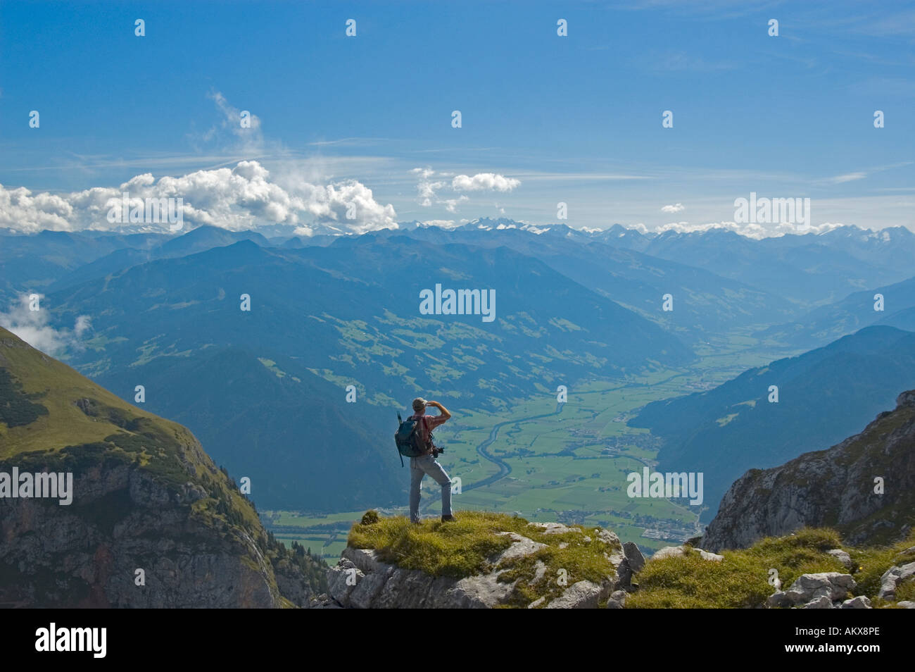 Hiker on Rofan mountains with view over valley of Inn to Zillertal ...