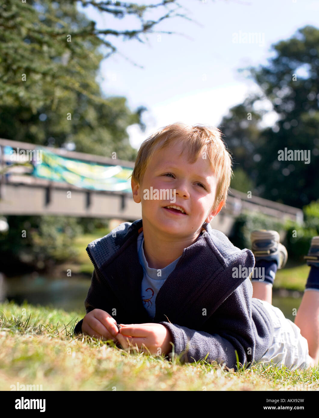 Boy relaxing on grass Stock Photo - Alamy