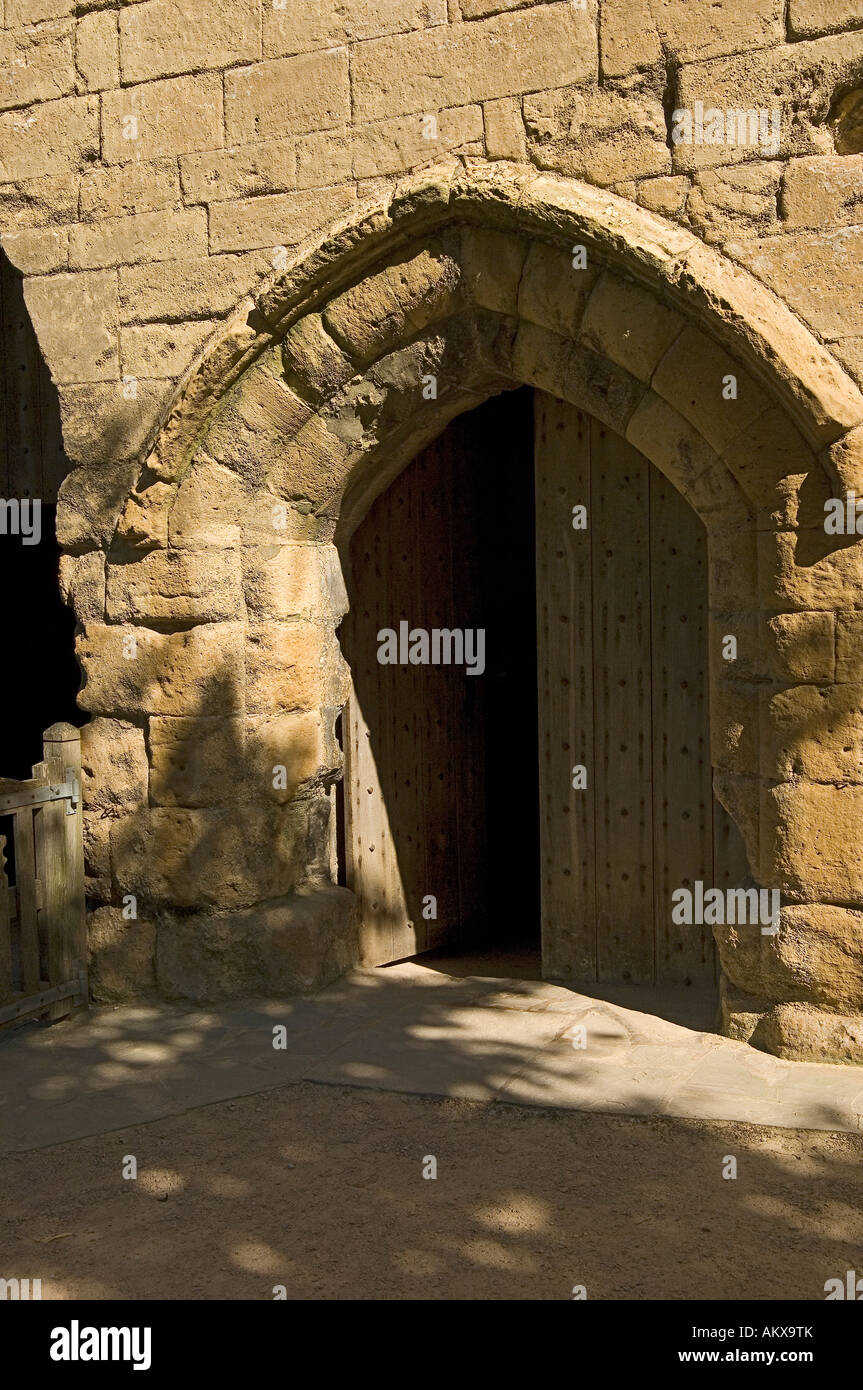 Open wooden door in stone wall Stock Photo - Alamy