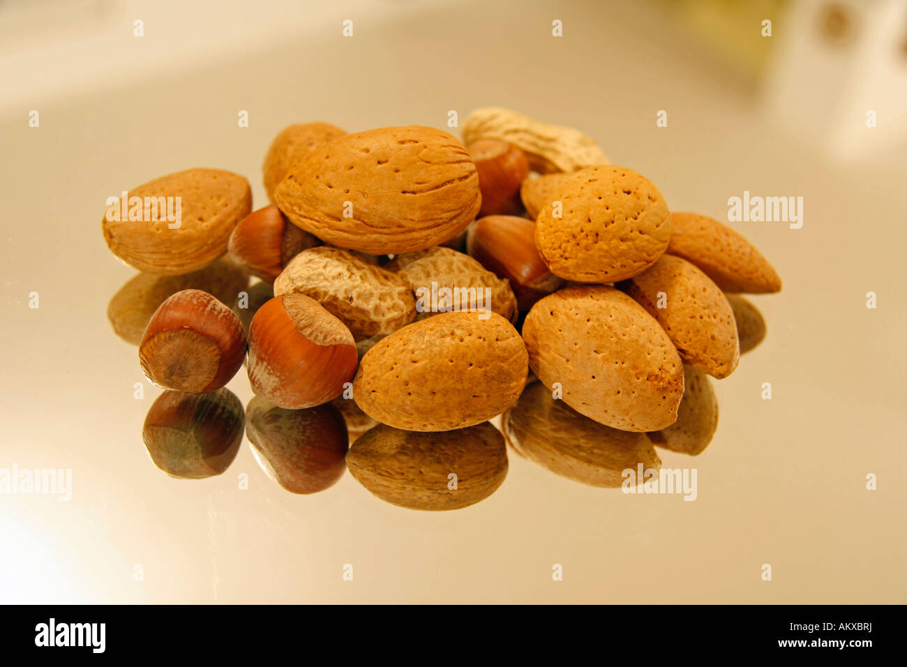 Nuts on a mirror Stock Photo - Alamy