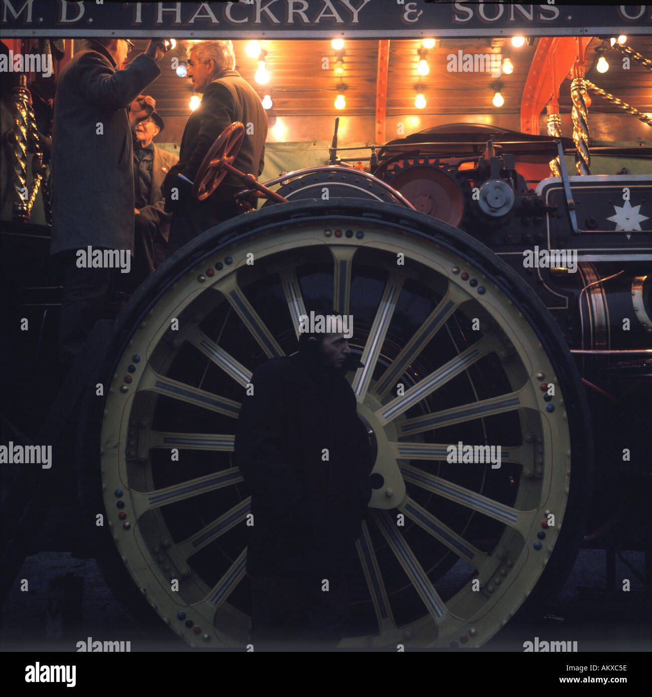 Showmans fairground steam traction engine dusk with lights men in ...