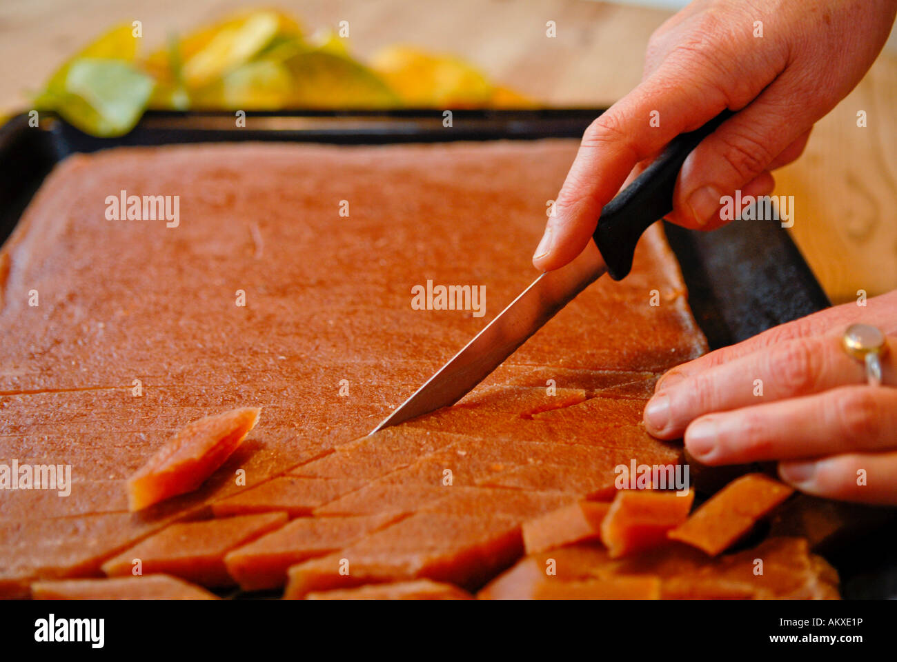 Fresh quince bread being cut by a knife Stock Photo - Alamy