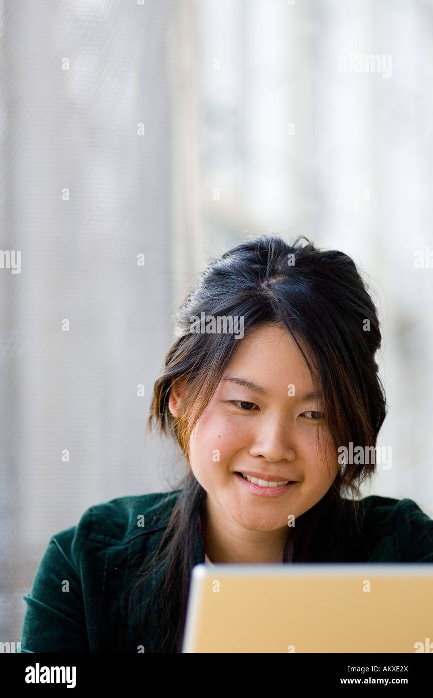 Young Asian university college student working on laptop computer Stock ...