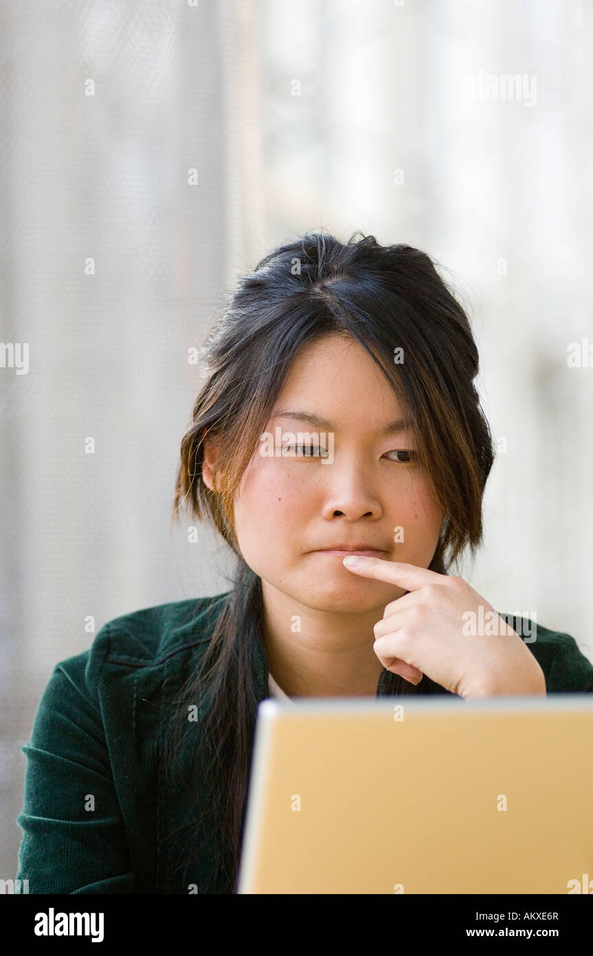 Young Asian university college student working on laptop computer Stock ...