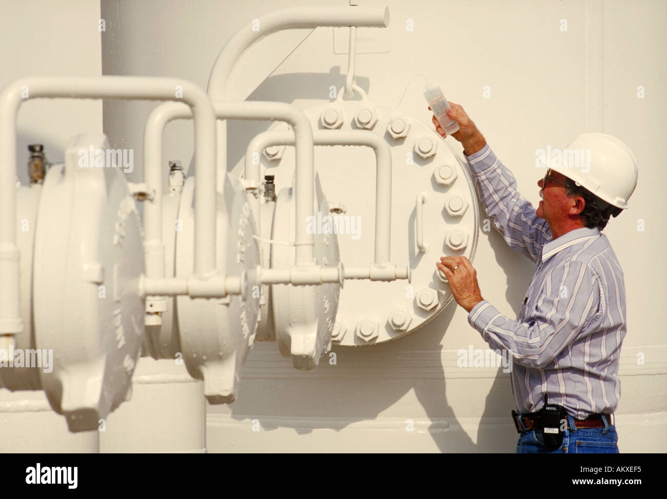 Supervisor inspecting natural gas pipeline at power cogeneration plant ...