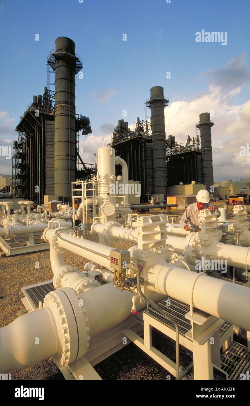 Supervisor opening valve in natural gas pipeline at power cogeneration ...