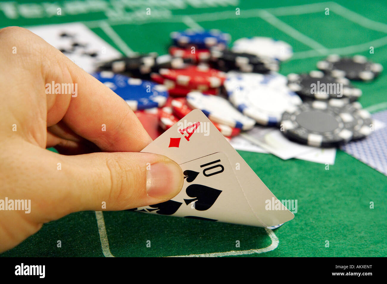 A Poker Player looks at his cards Stock Photo - Alamy