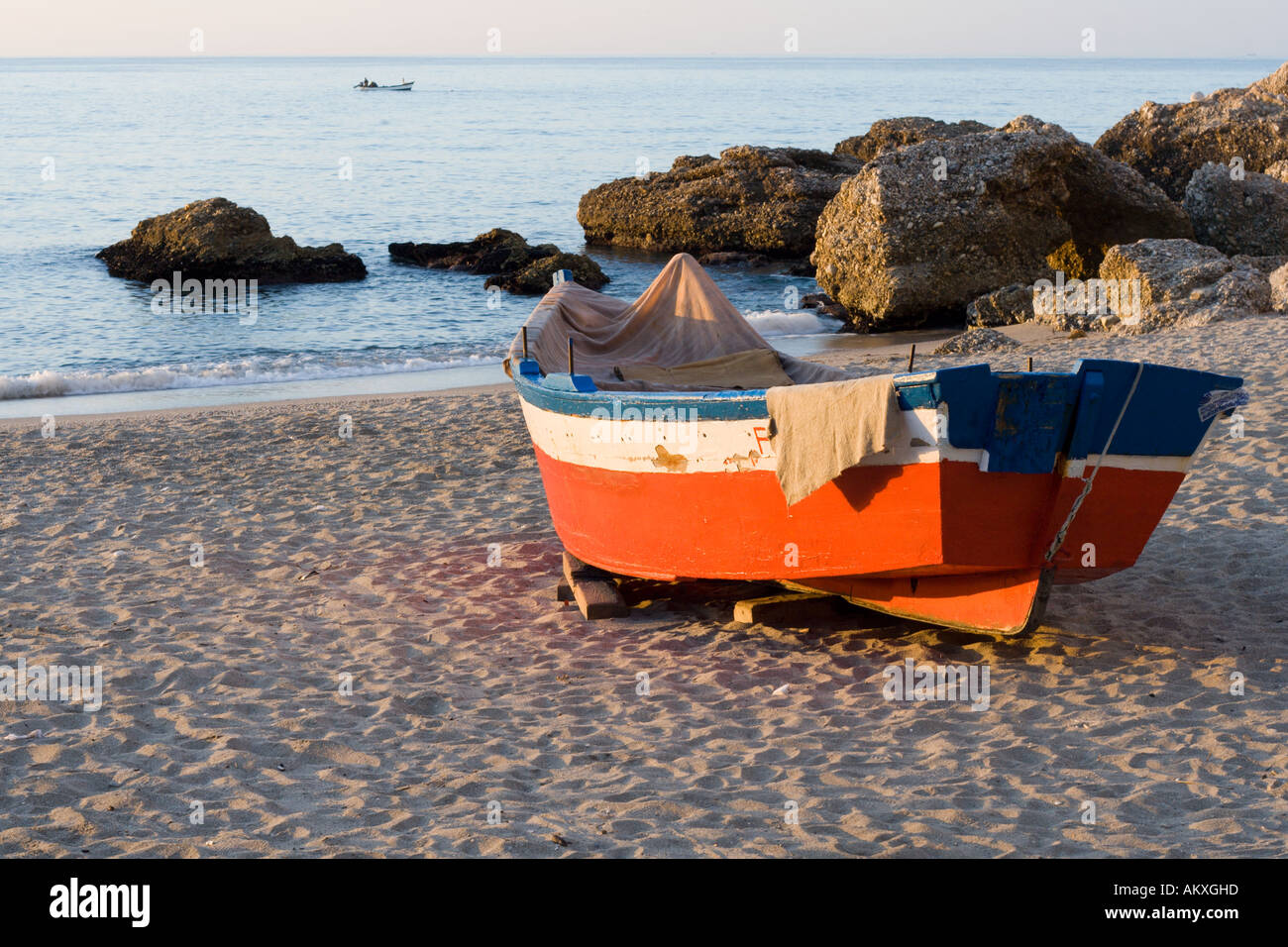 Small red, white and blue fishing boat Stock Photo - Alamy