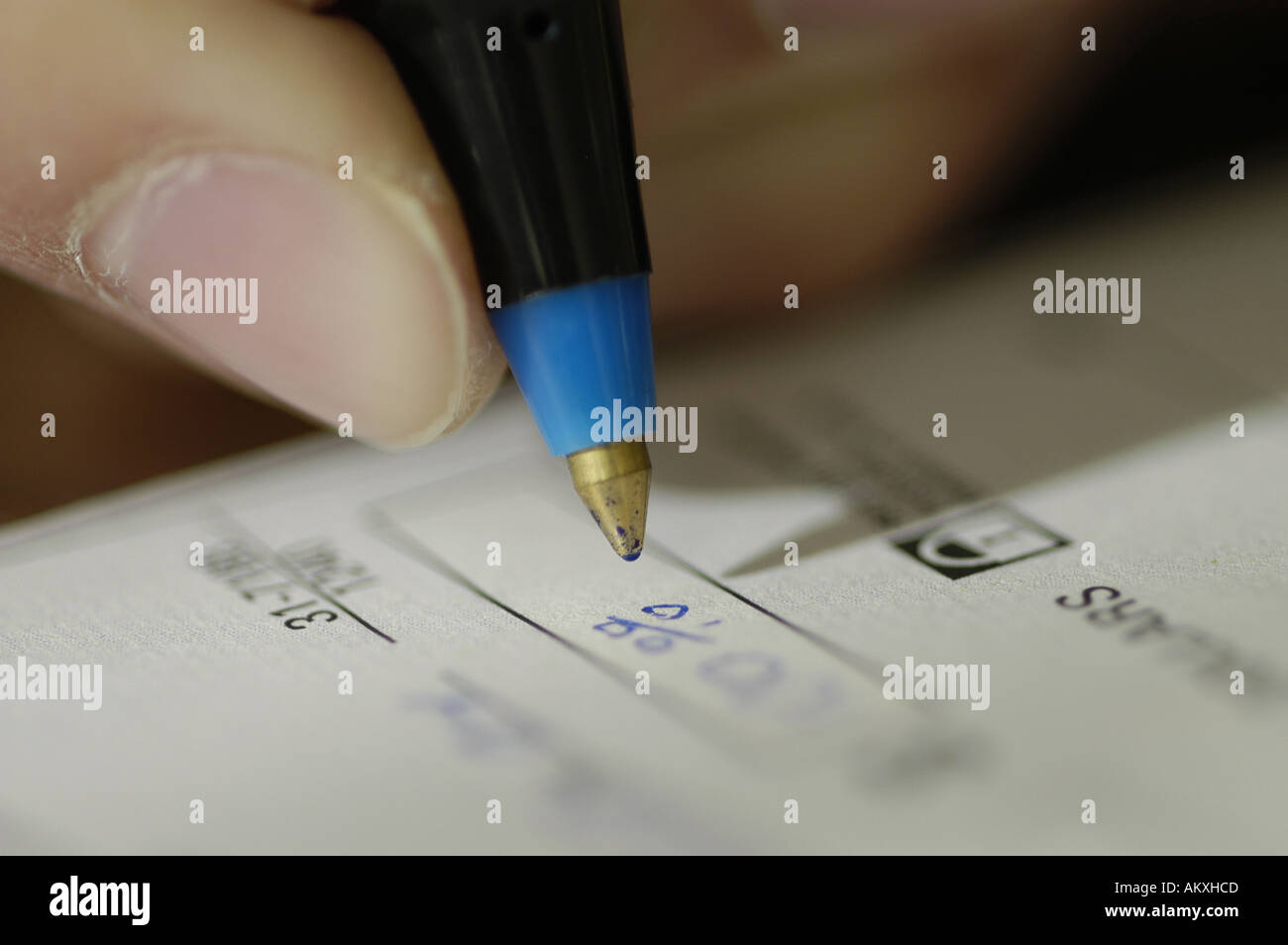 A person writing out a check Stock Photo - Alamy