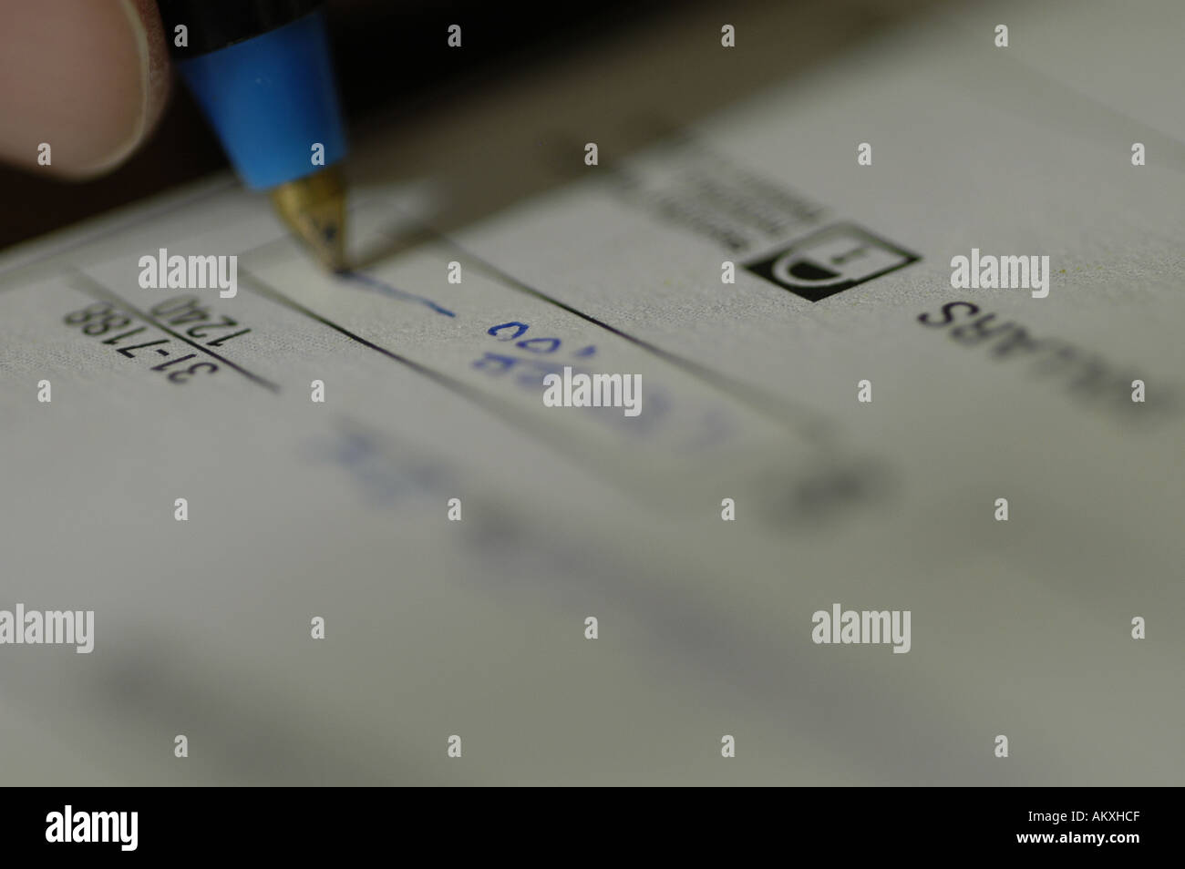 A person writing out a check Stock Photo - Alamy