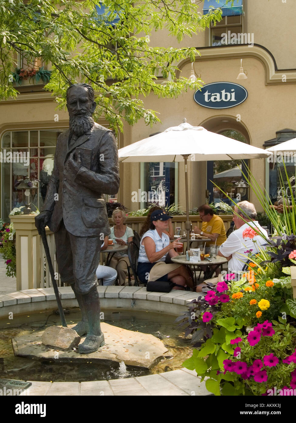 People dine outside Tabi Restaurant next to a statue of George Bernard ...