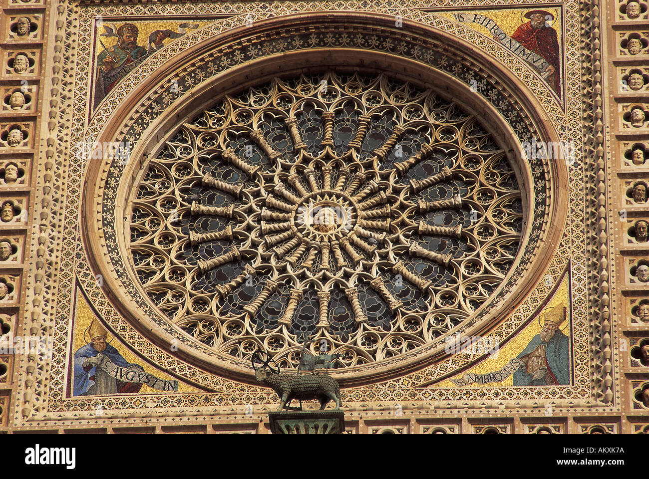 The rose window with tracery surrounded by golden mosaics on the 16th c ...