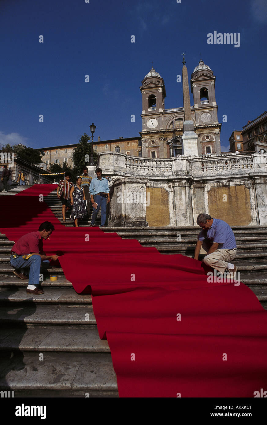 Men at work laying a long red carpet the length of the Spanish Steps in ...