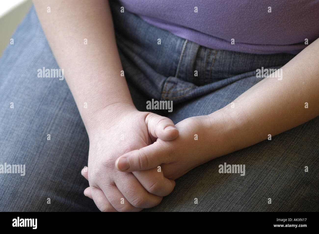 A person's folded hands Stock Photo - Alamy