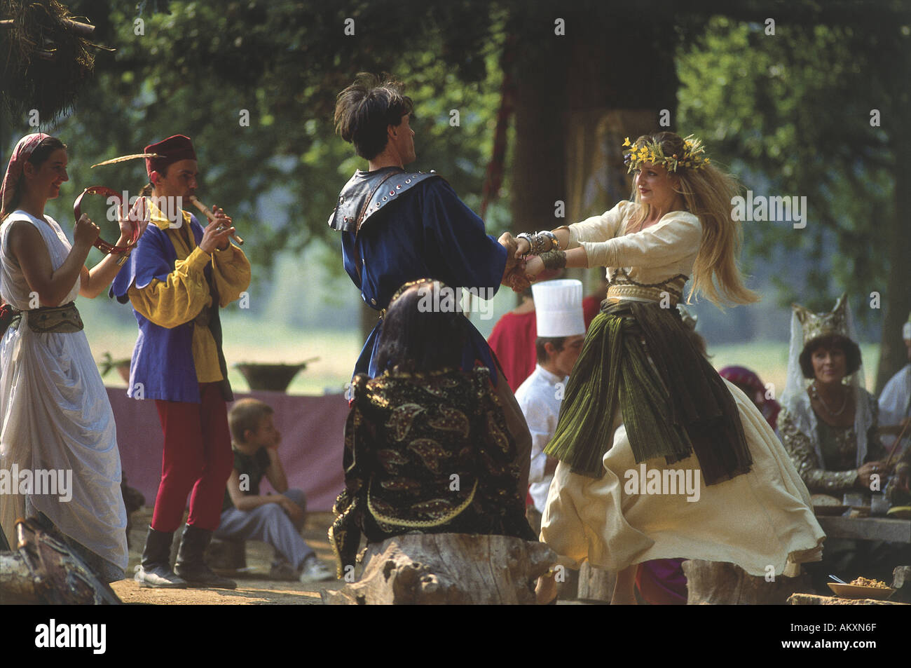 Wandering minstrels perform as a couple dressed in authentic costume ...