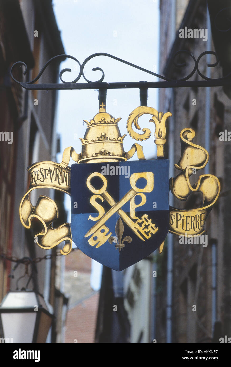 The towns crest in blue and gold on a sign hanging over a street in ...