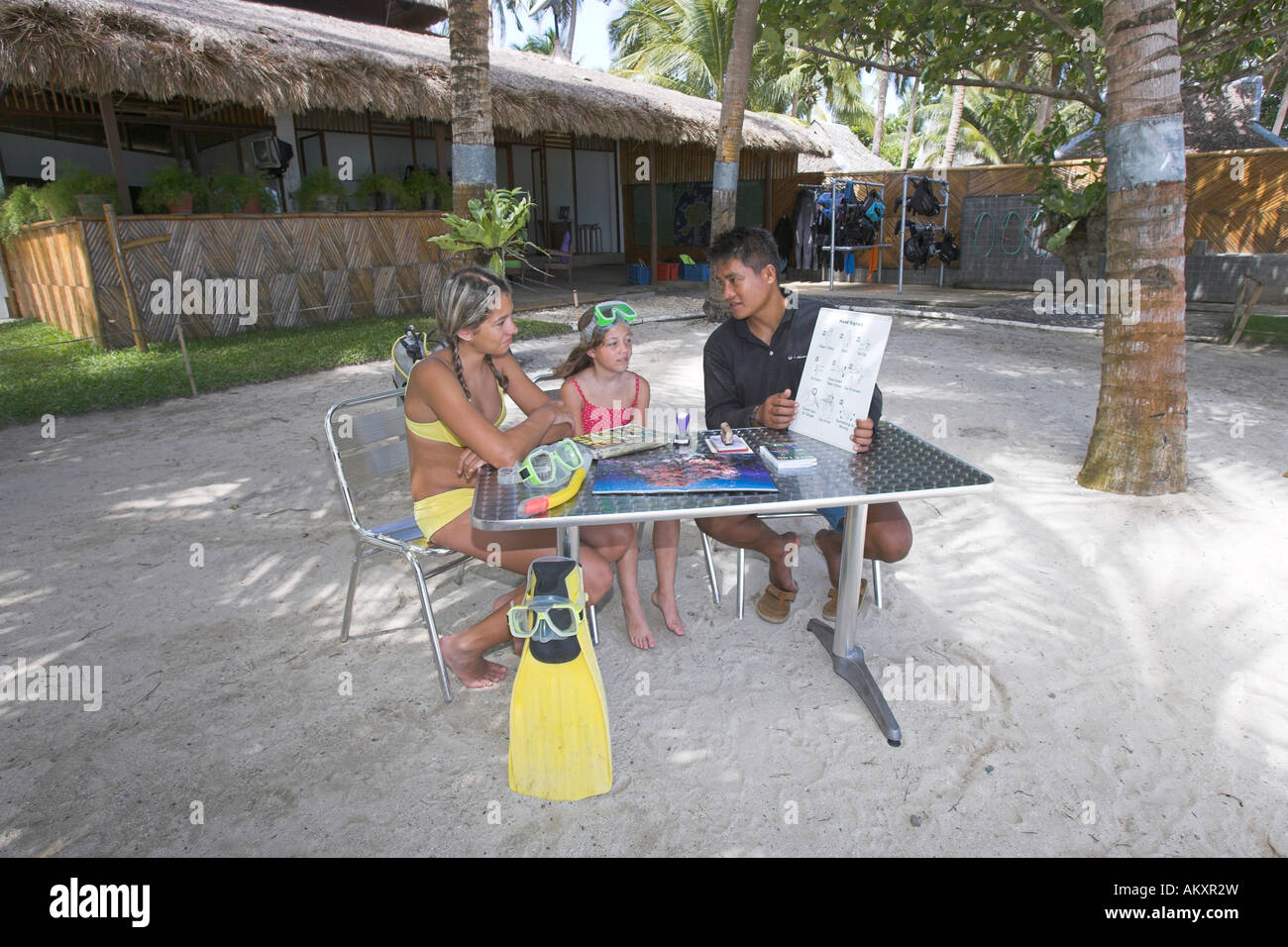 Diving teacher and two diving pupils in front of a diving school ...