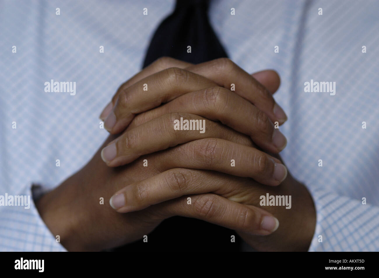 A person's folded hands Stock Photo - Alamy