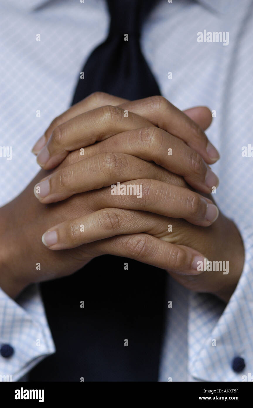 A person's folded hands Stock Photo - Alamy