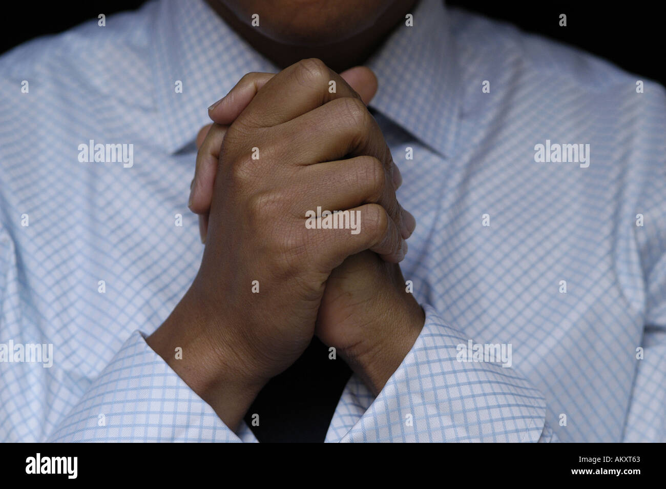 A person's folded hands Stock Photo - Alamy