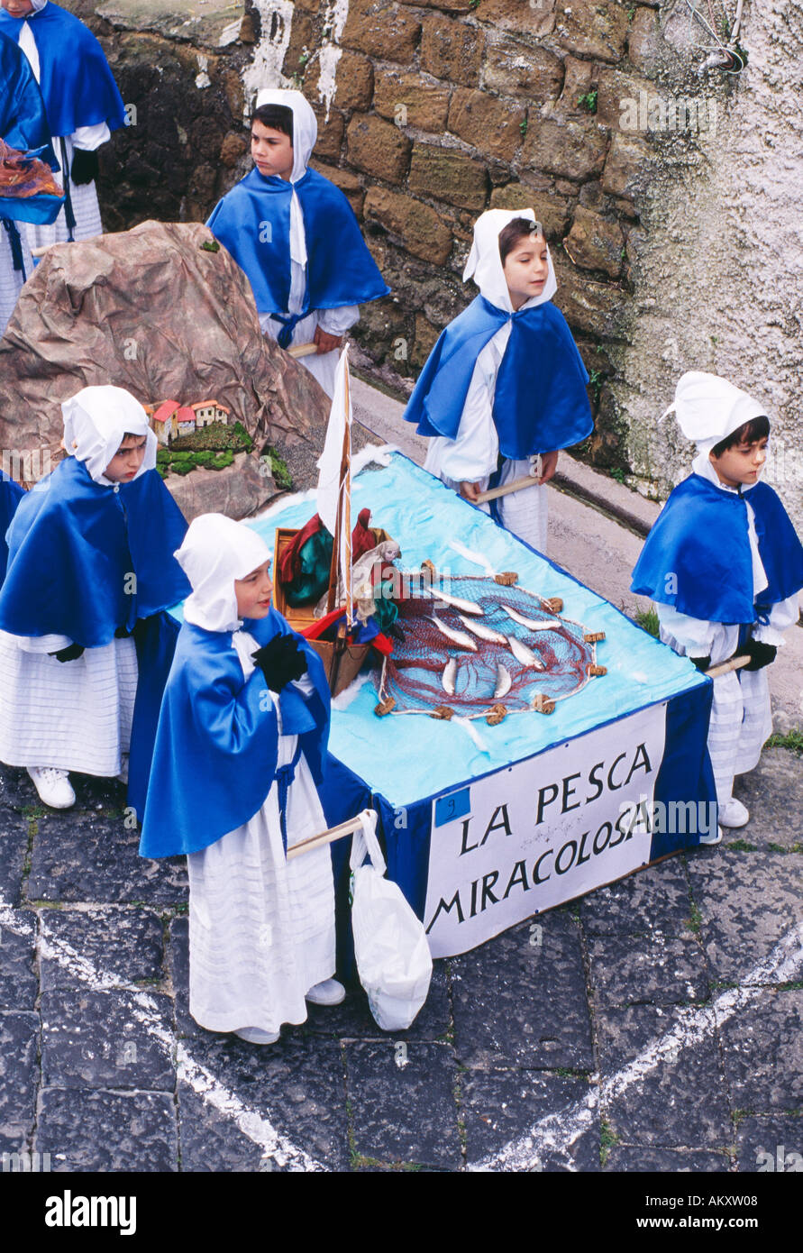 Girls in blue and white costumes carrying a float in the Easter Parade ...