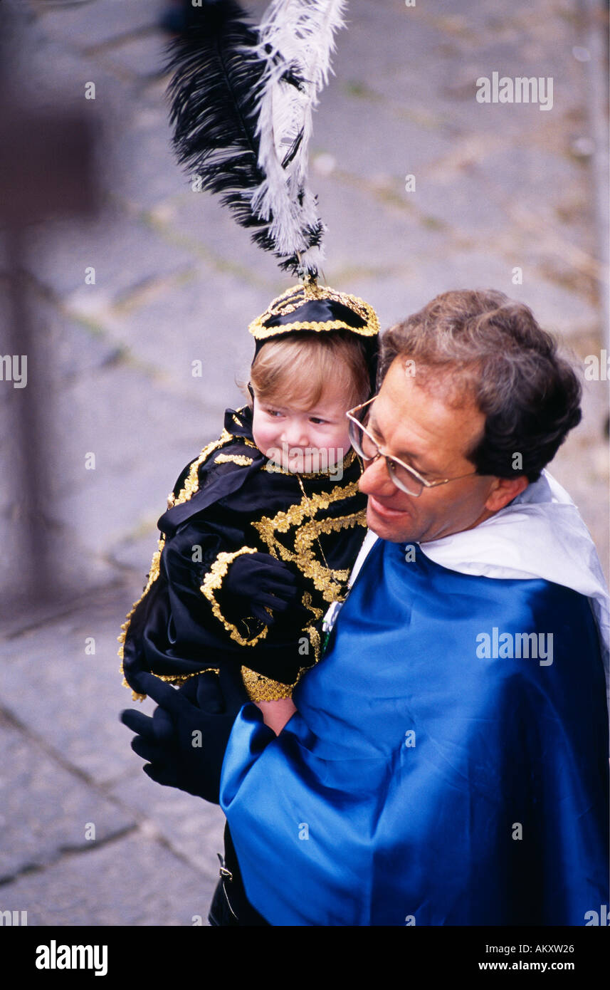A man carring young child in costume for the easter Parade in Naples ...