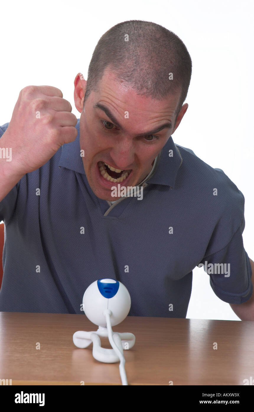 A young male computer experiencing Internet rage and about to smash his ...