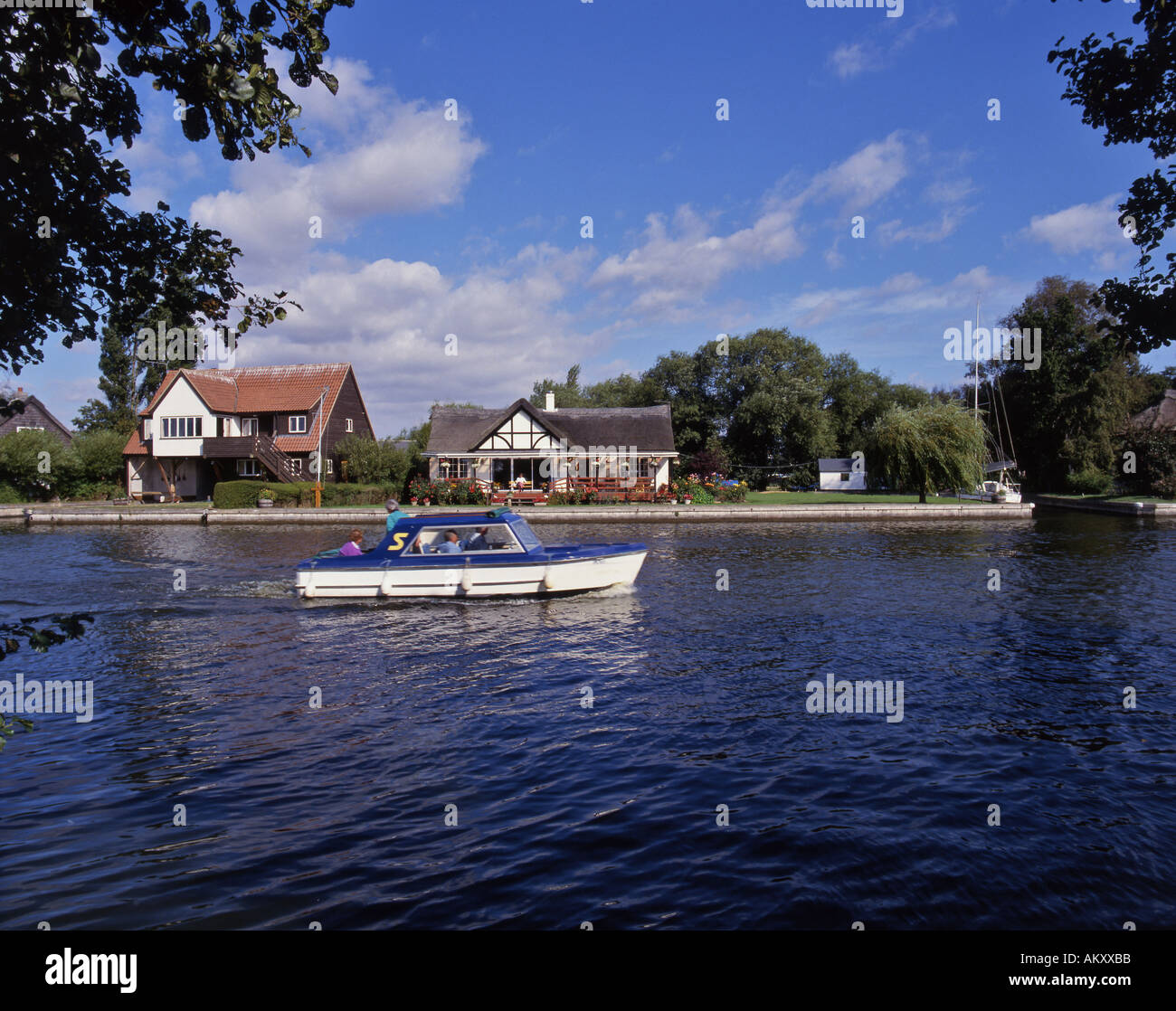Riverside dwellings boating on river Bure at Horning Norfolk England ...