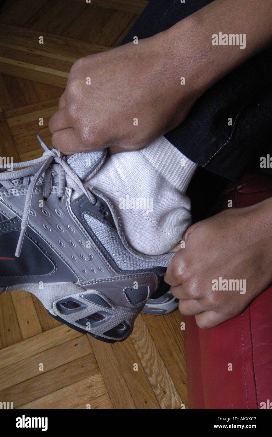 A close-up of a person putting on sneakers Stock Photo - Alamy