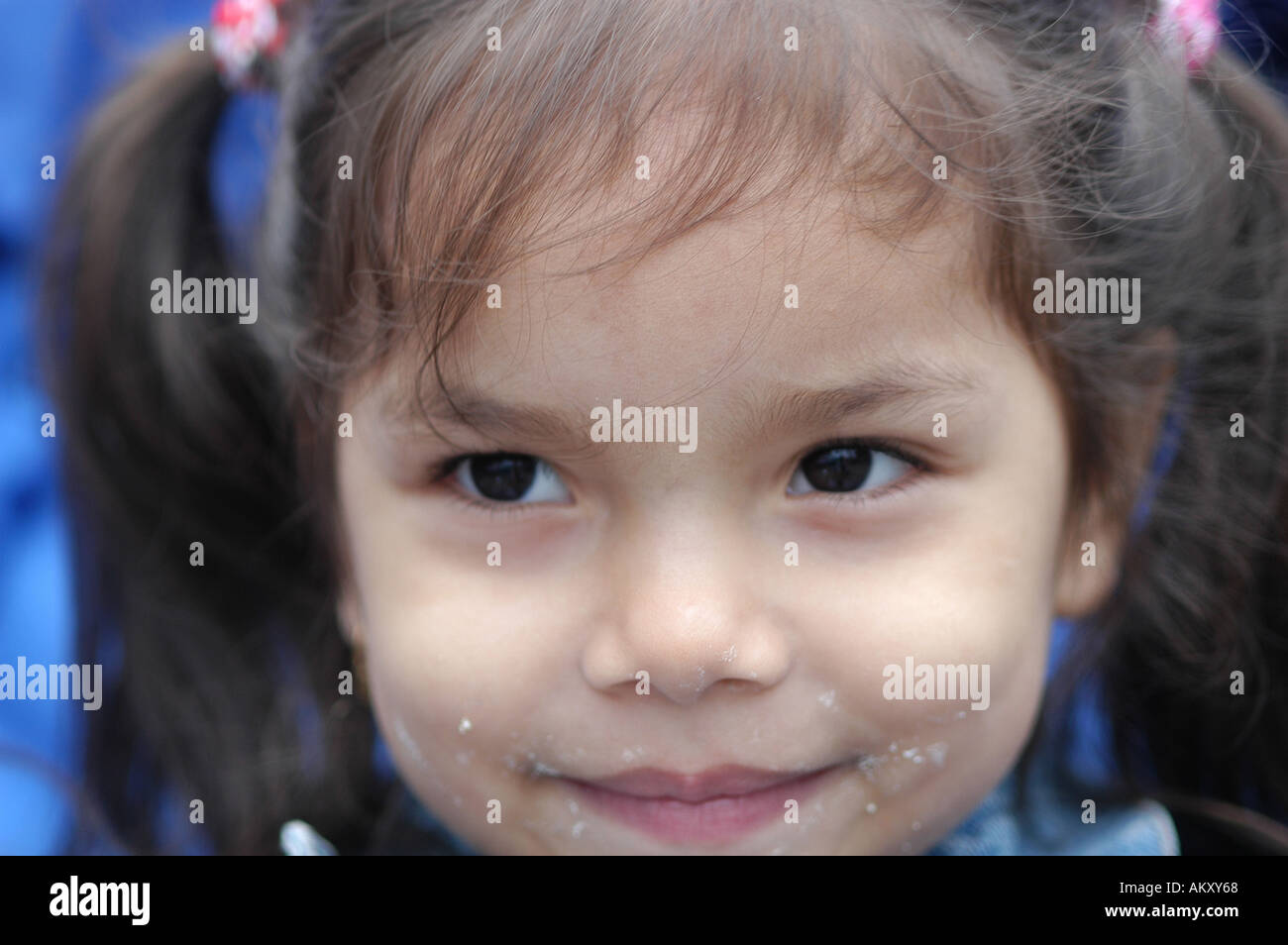 A portrait of a young girl with crumbs on her face Stock Photo - Alamy