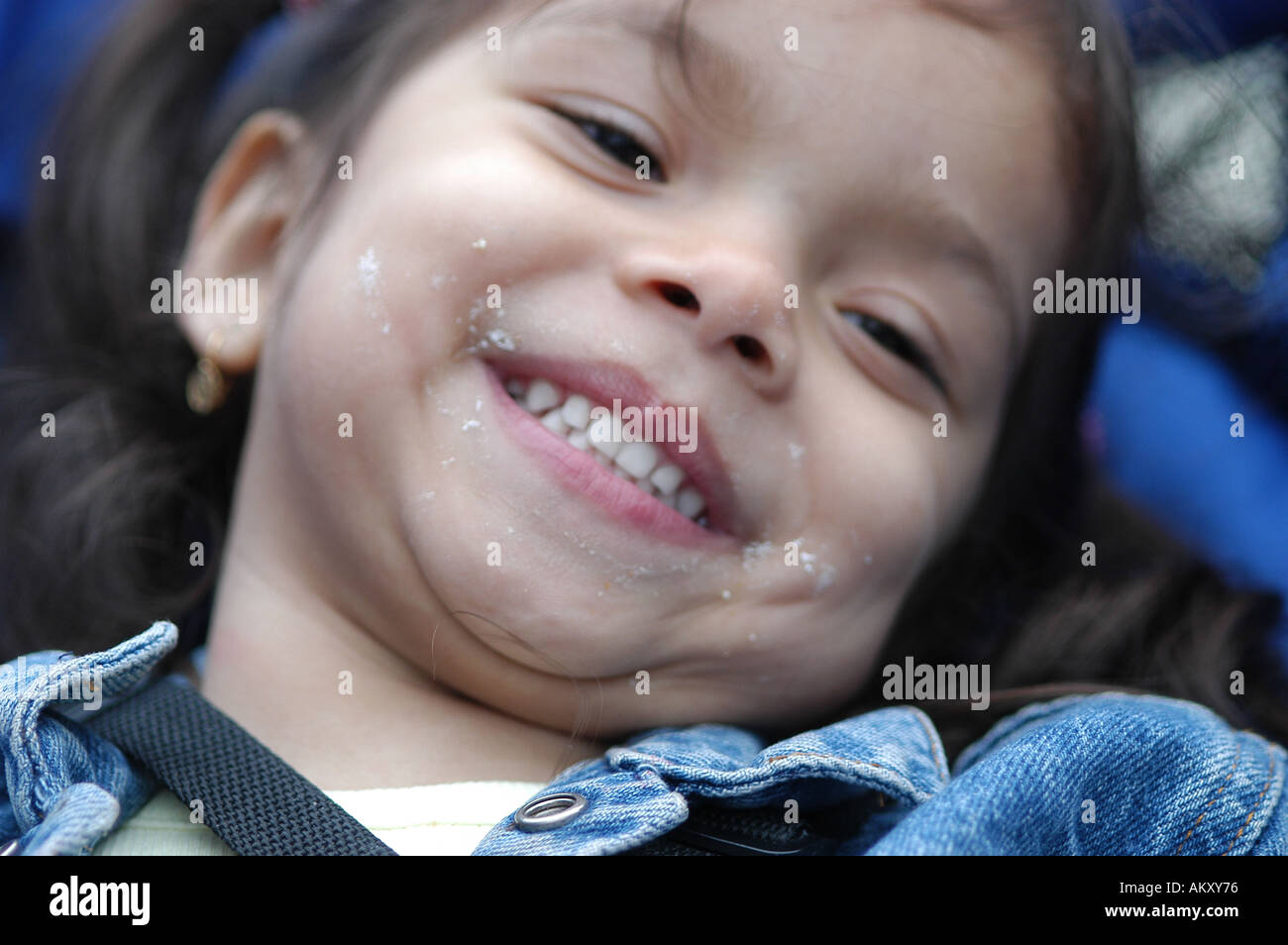 A portrait of a young girl with crumbs on her face Stock Photo - Alamy