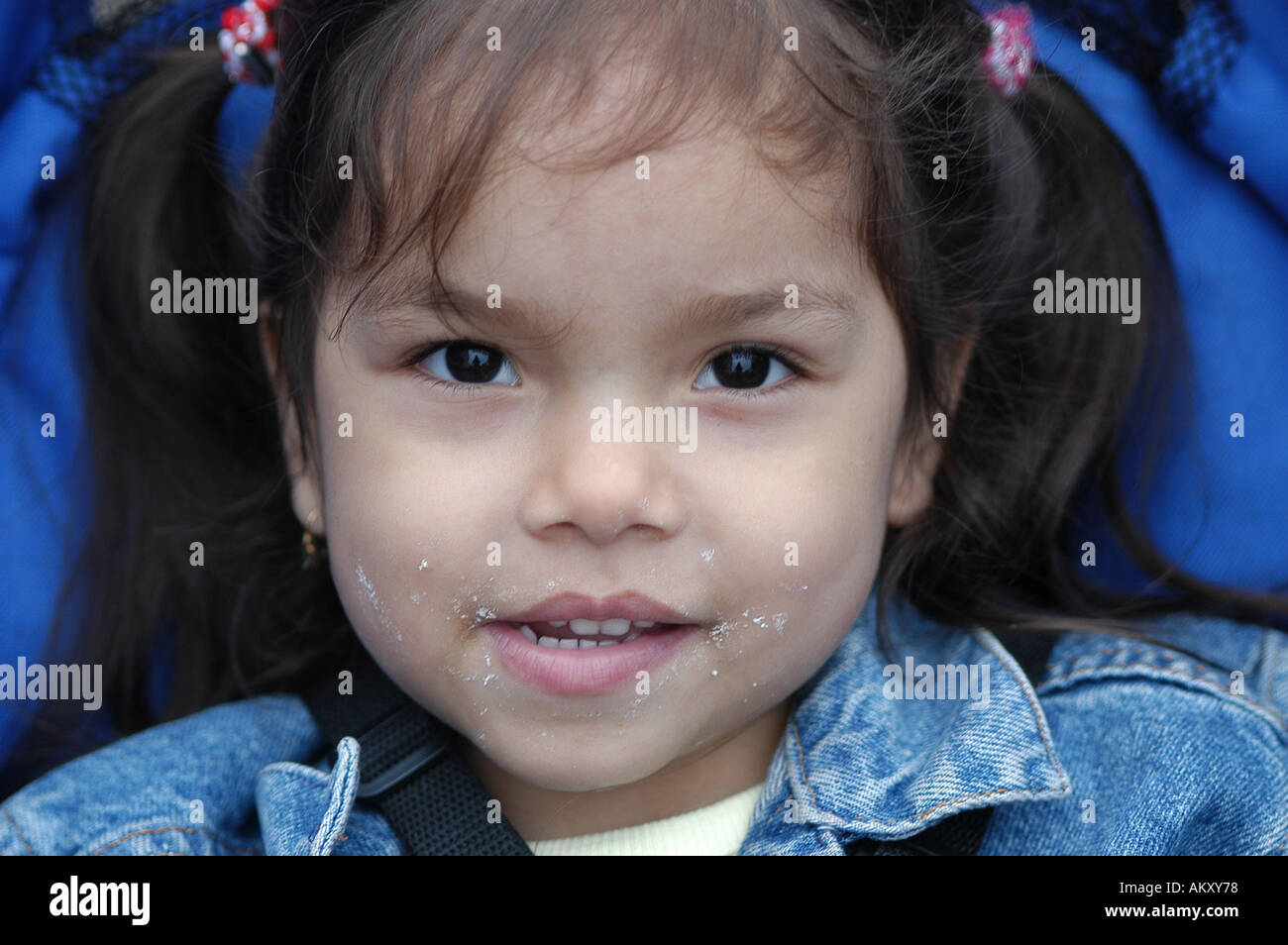 A portrait of a young girl with crumbs on her face Stock Photo - Alamy