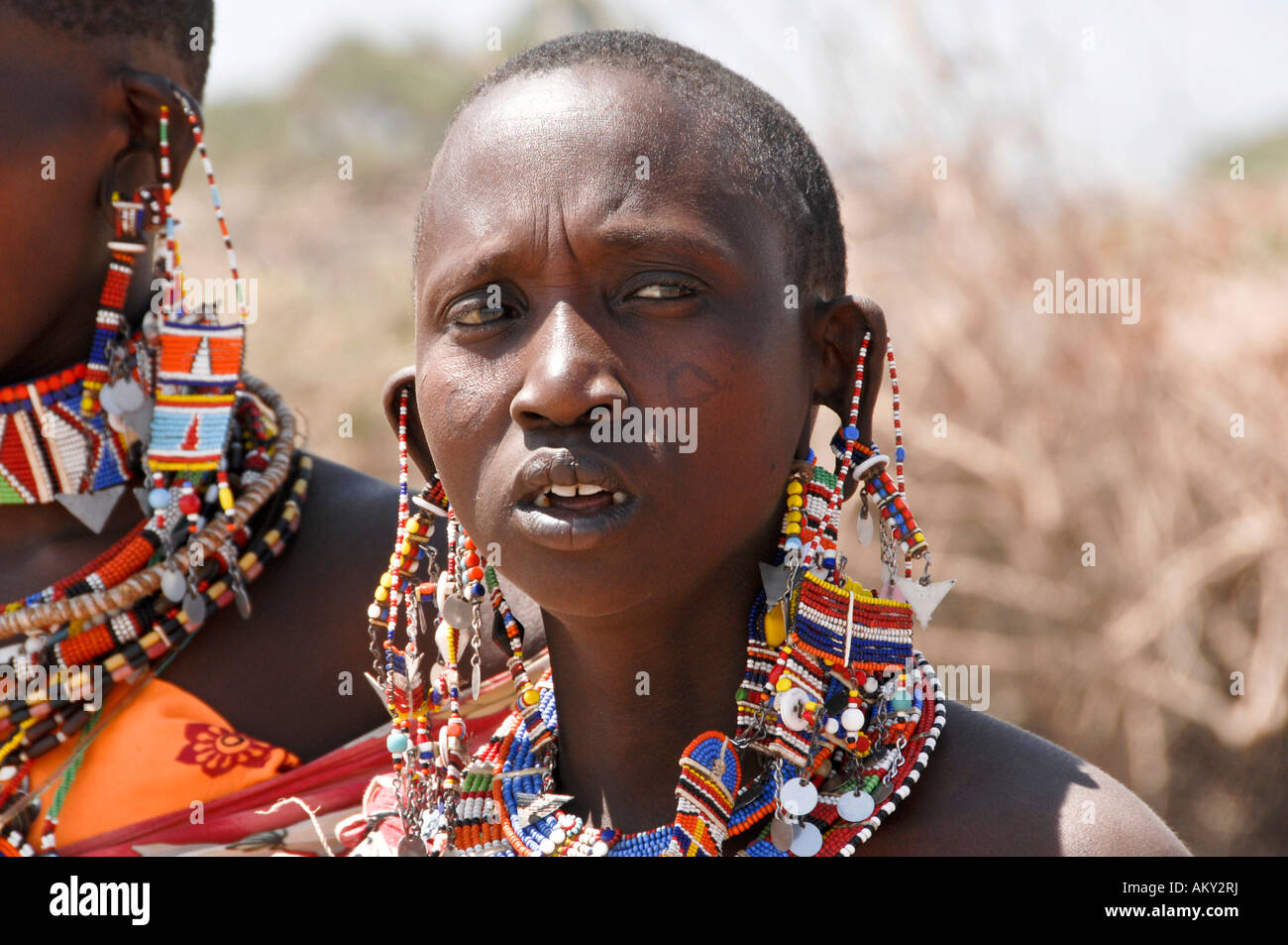 Massai, Massai woman in colourful clothes and with traditional ...