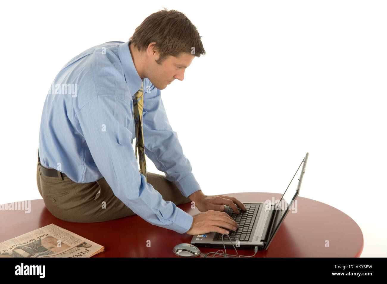 Young business man working on a laptop computer in an office ...