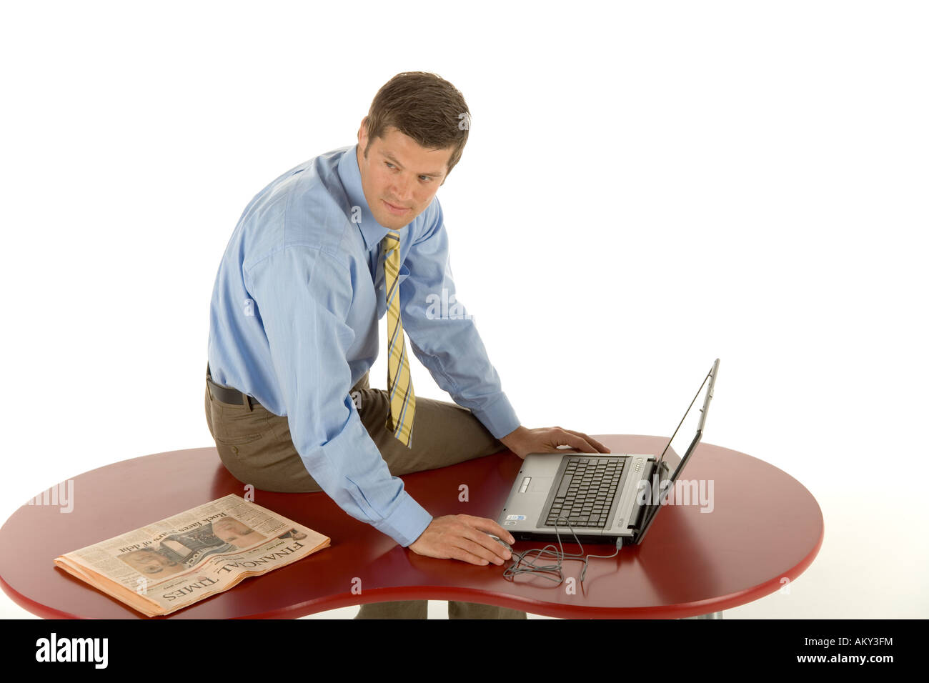 Young business man working on a laptop computer in an office ...