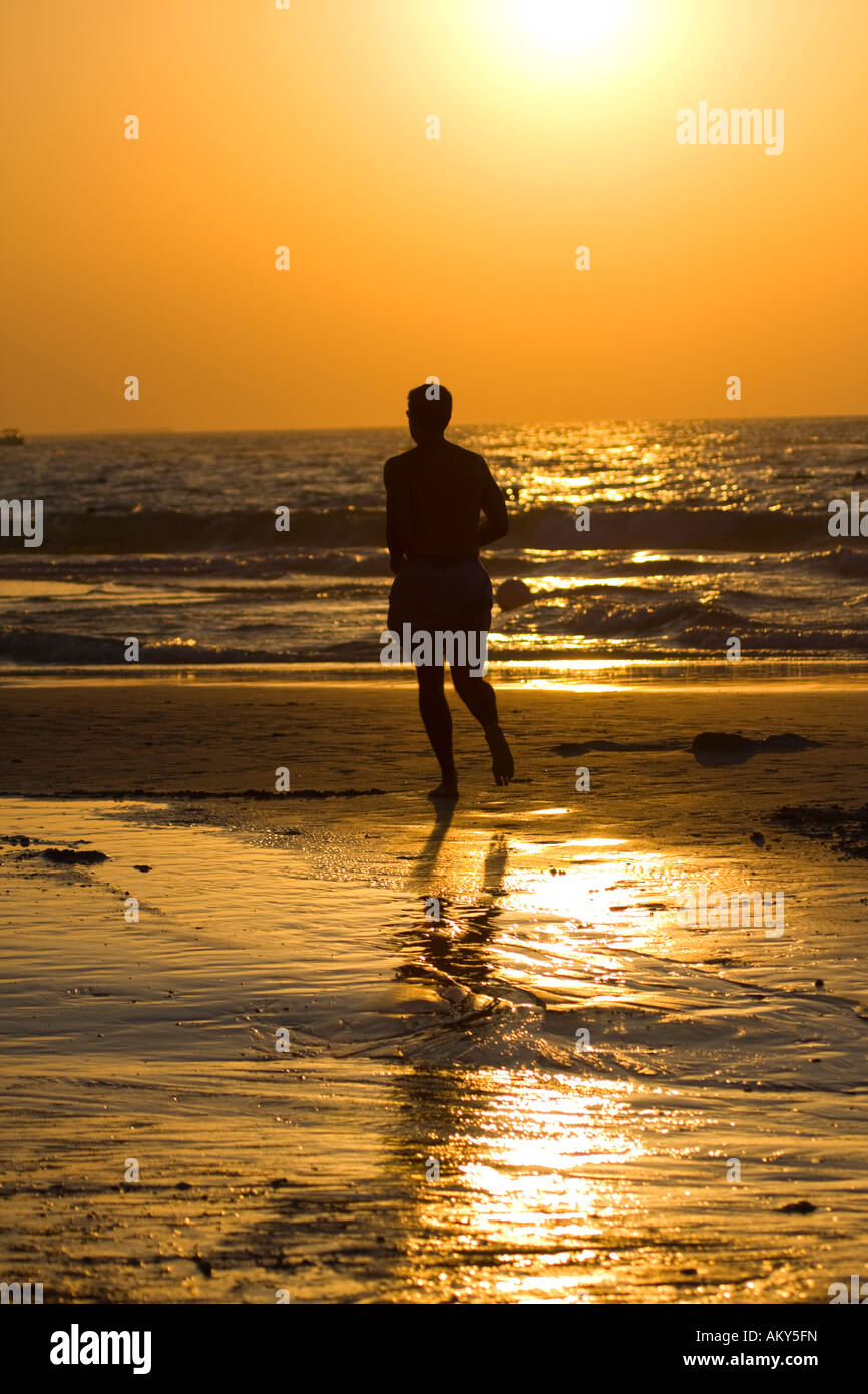 Lone Jogger on sunset beach Stock Photo - Alamy